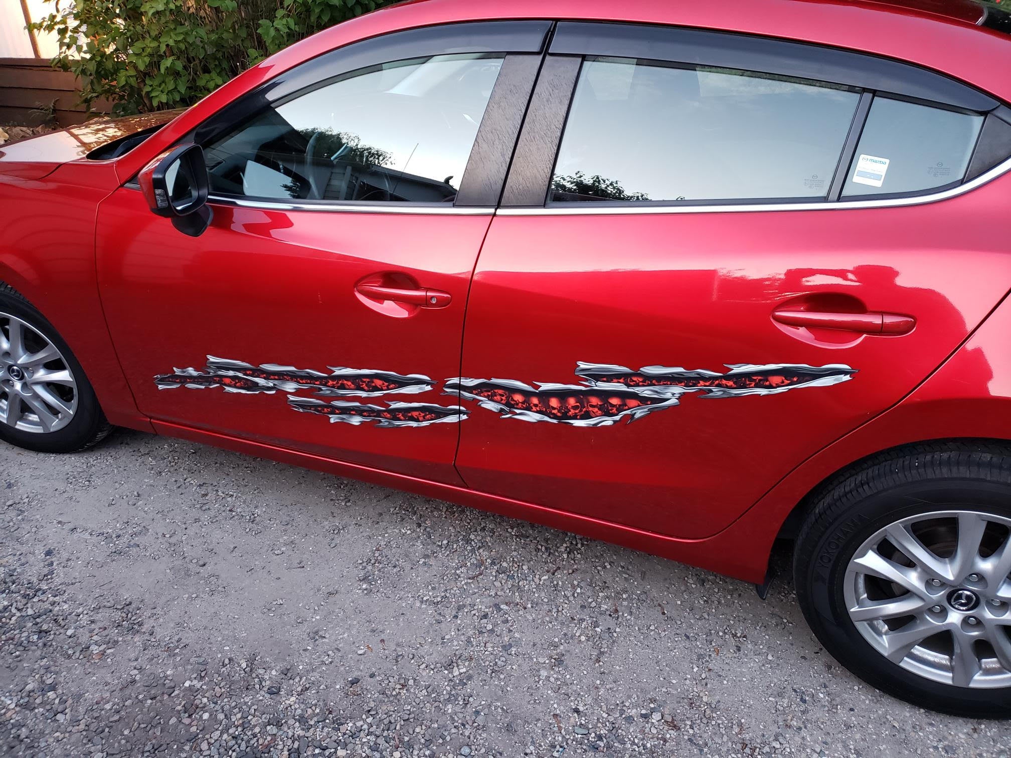 Skulls ripped metal decals on side of red car | Xtreme digital graphiX ...